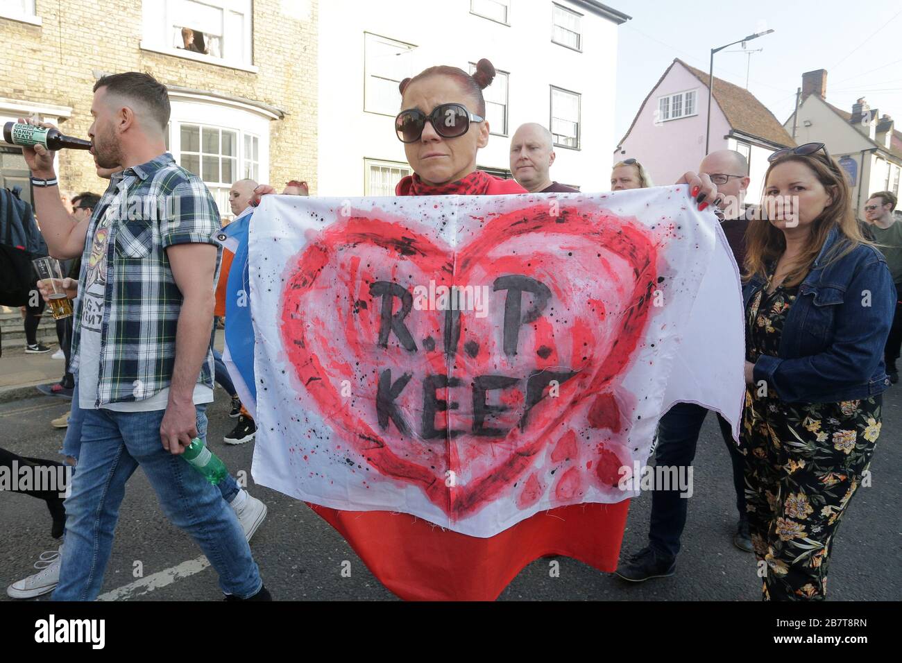 A fan holds a RIP Keef flag as the funeral procession of Prodigy singer ...