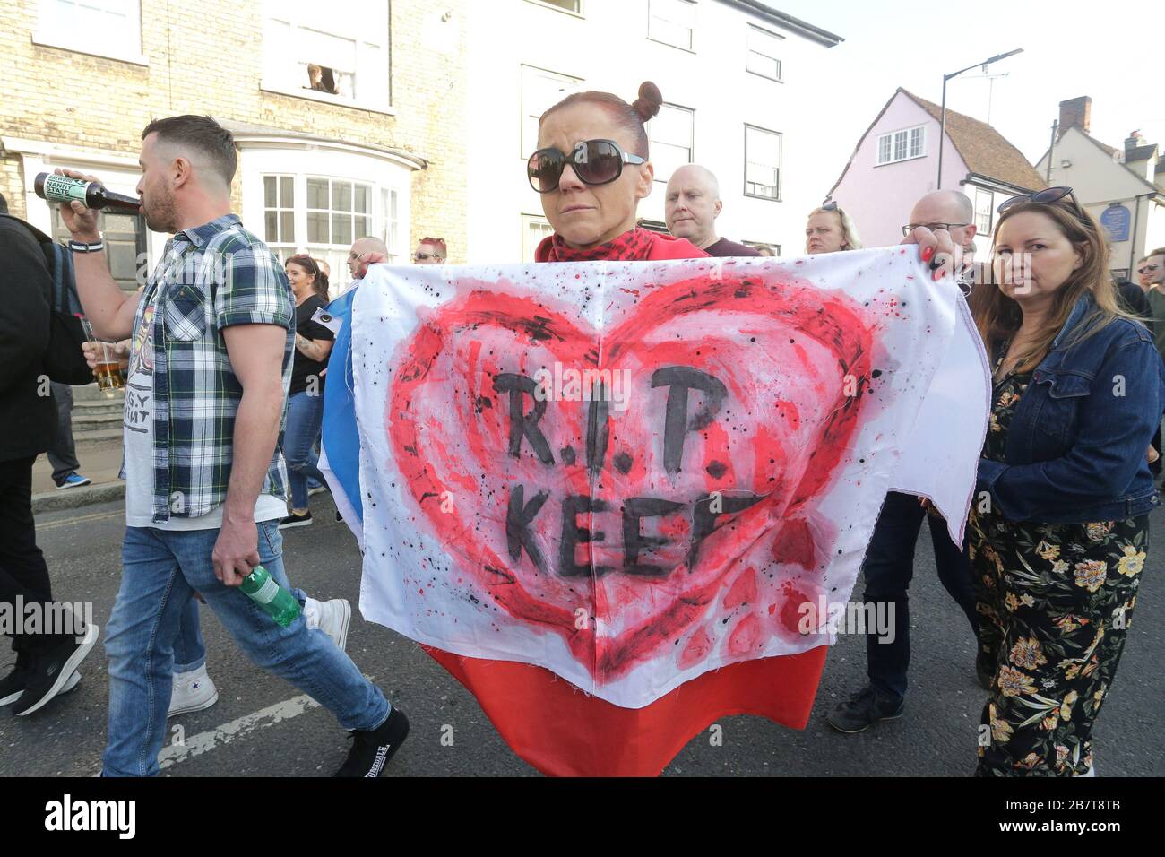 A fan with a RIP Keef flag follows the funeral procession of Prodigy ...