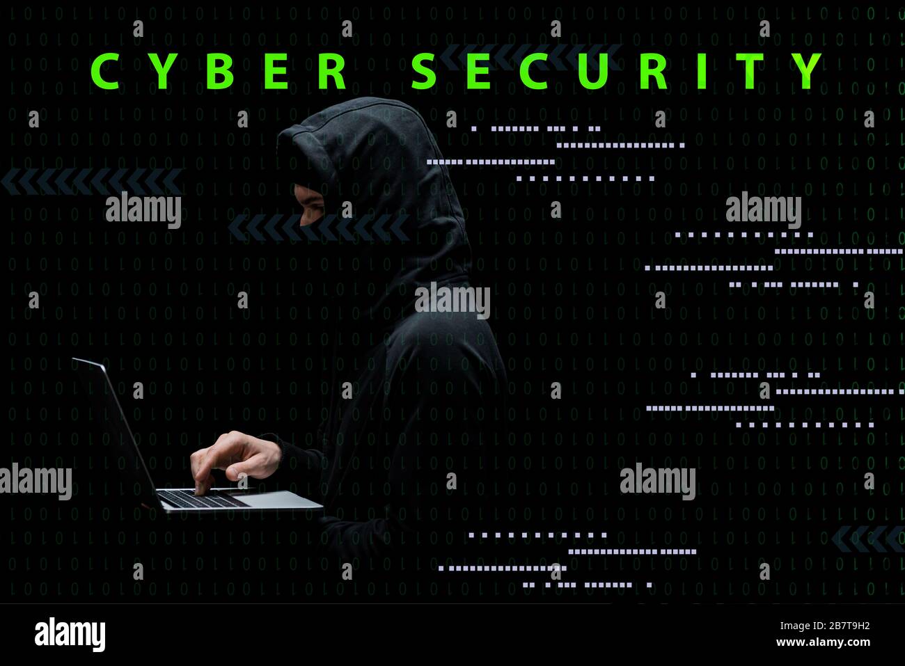 anonymous man in hood and mask using laptop near cyber security ...