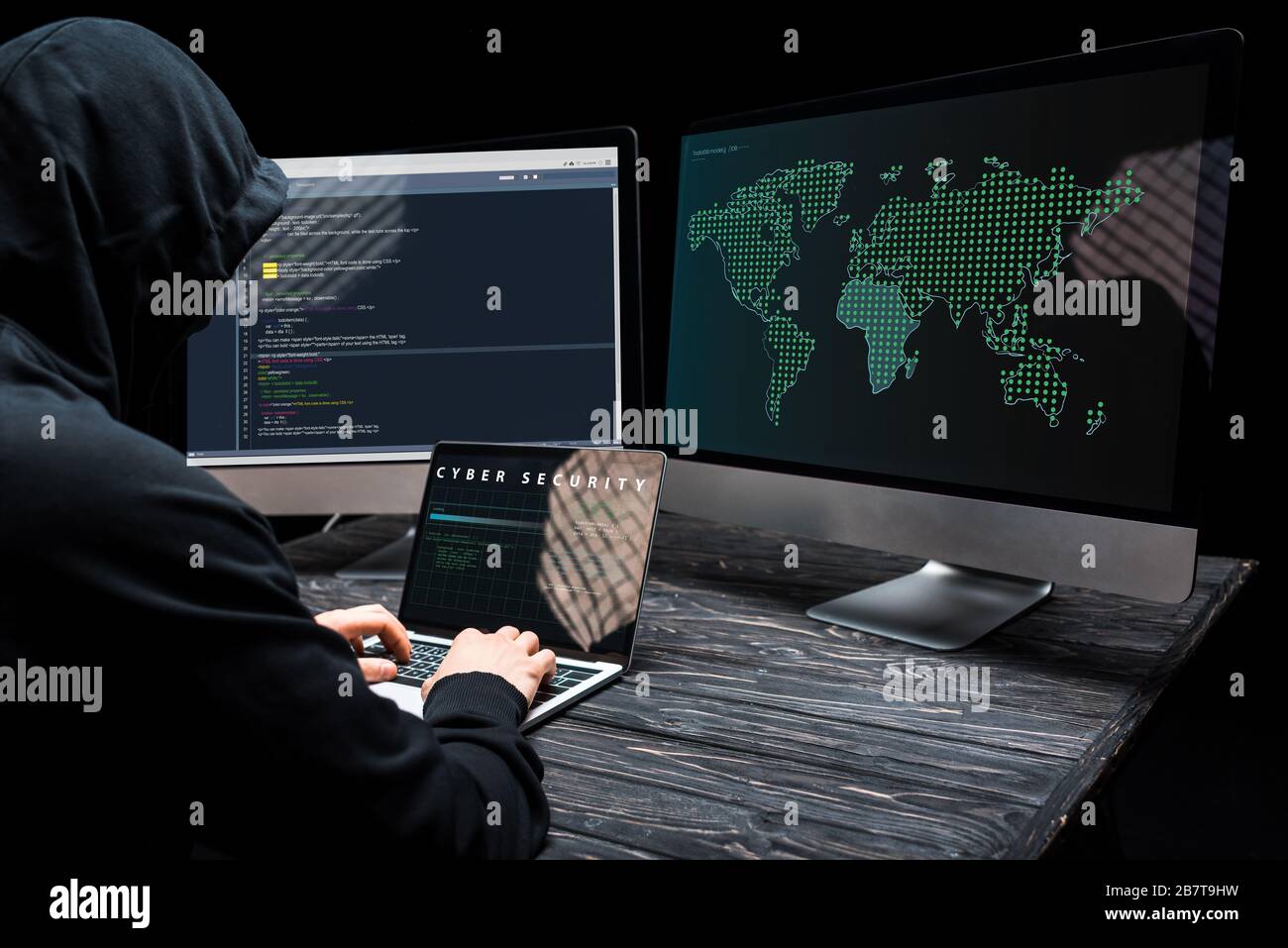 hacker using laptop with cyber security lettering on screen near ...