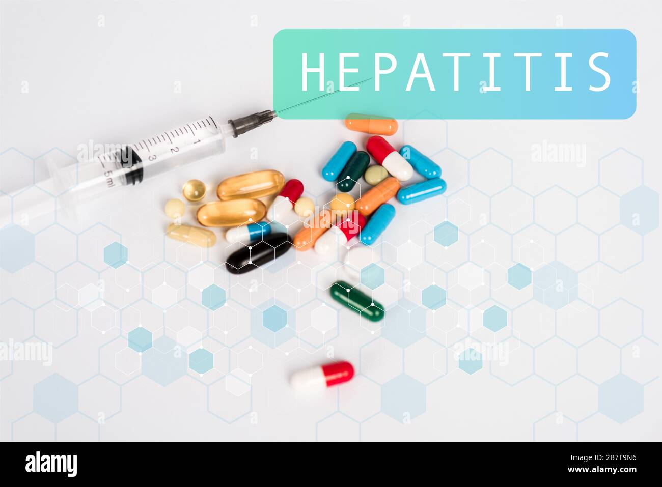 colorful pills near syringe and hepatitis lettering on white Stock ...