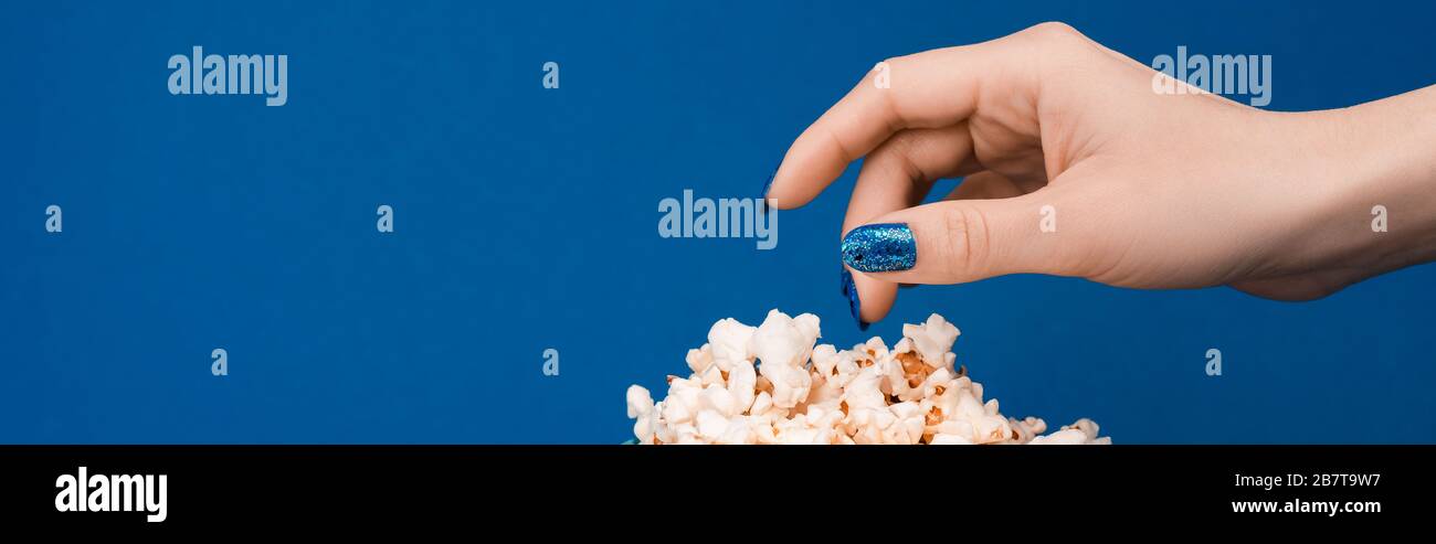 Woman taking delicious popcorn hi-res stock photography and images - Alamy