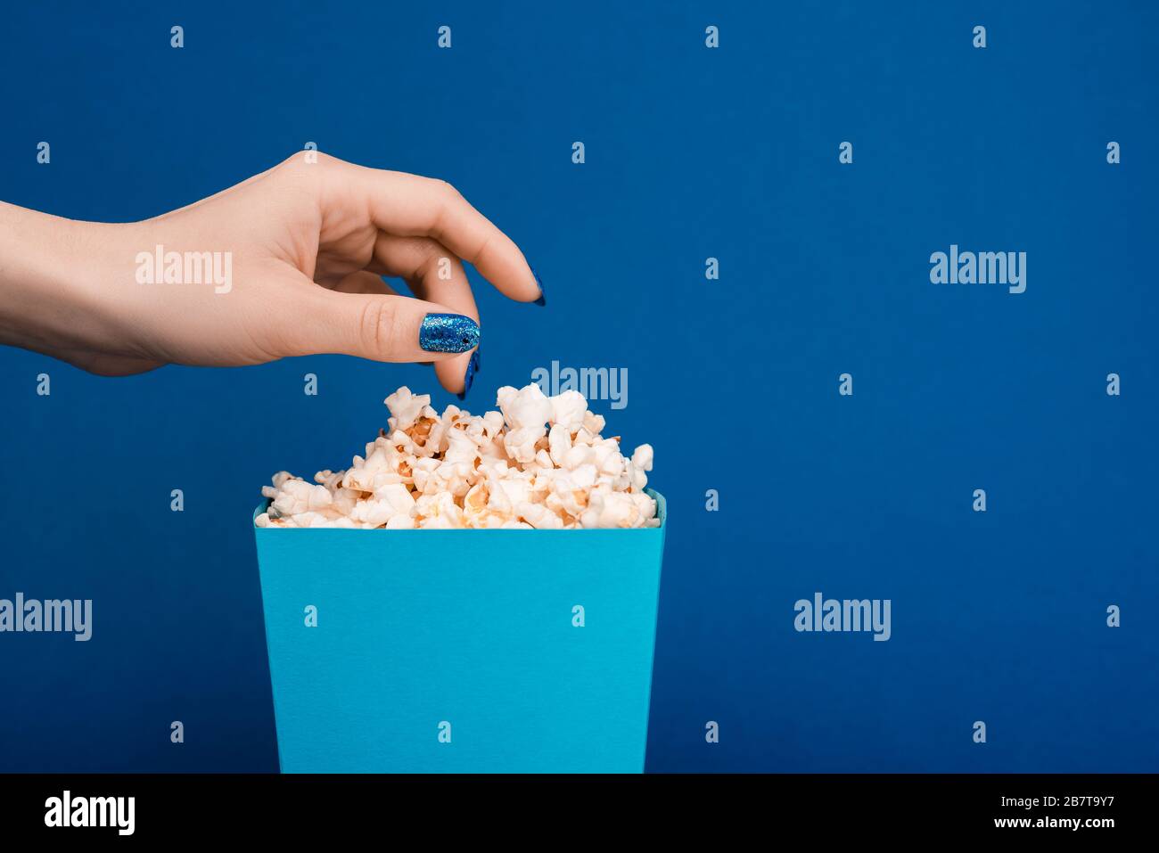 Woman taking delicious popcorn hi-res stock photography and images - Alamy