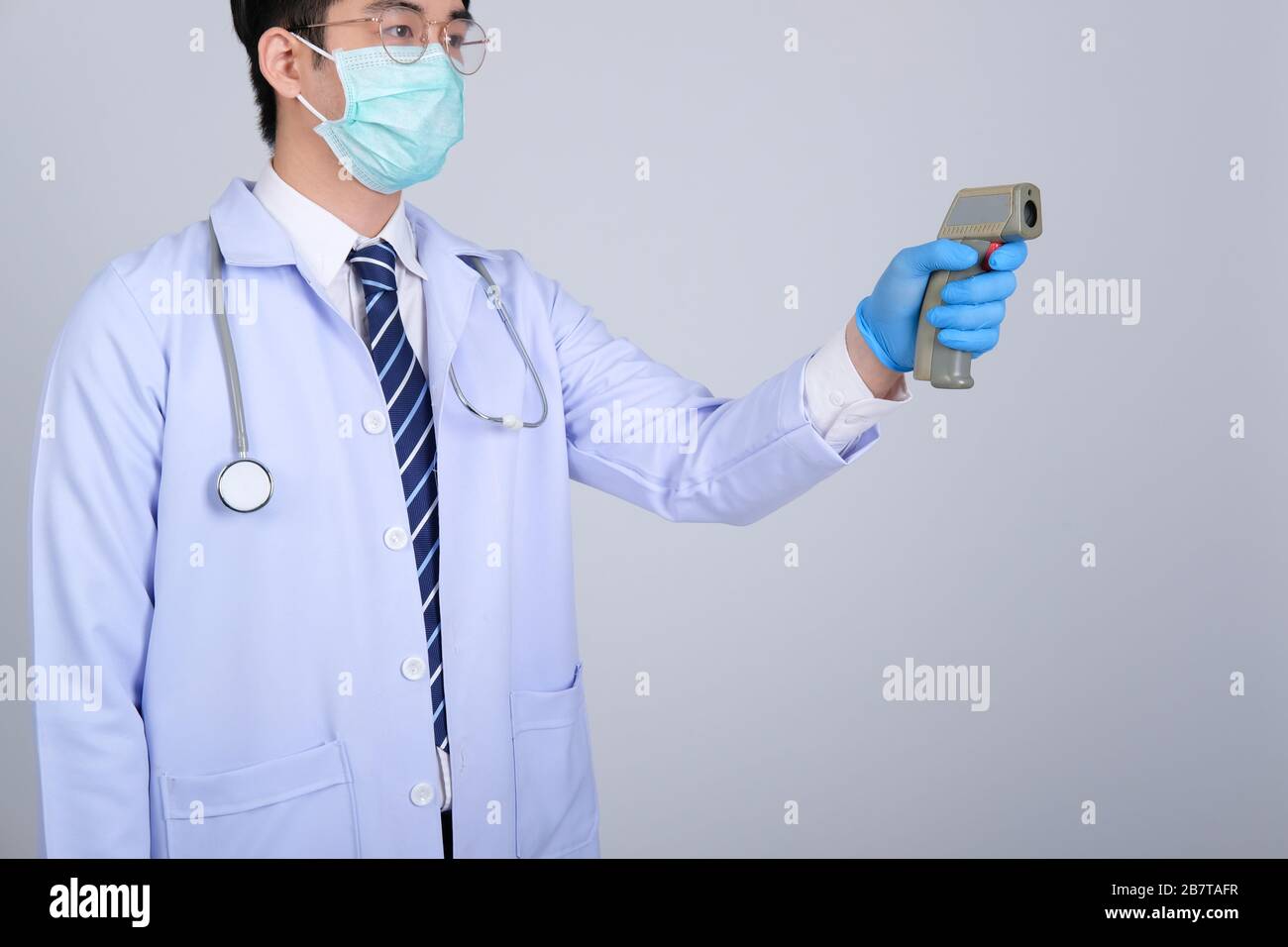 doctor physician practitioner measuring body temperature with ...