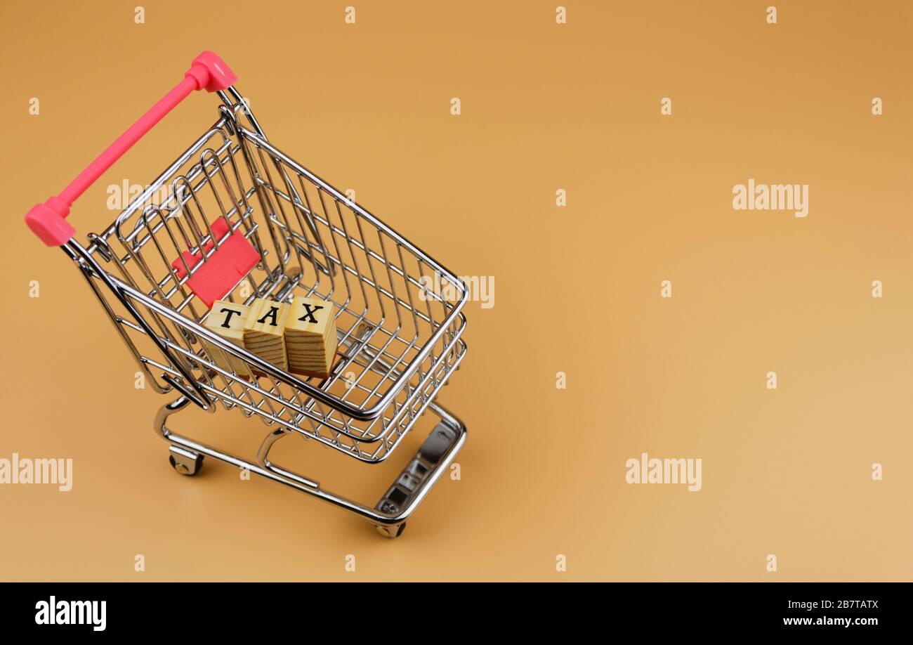 tax word in cart on orange background Stock Photo - Alamy