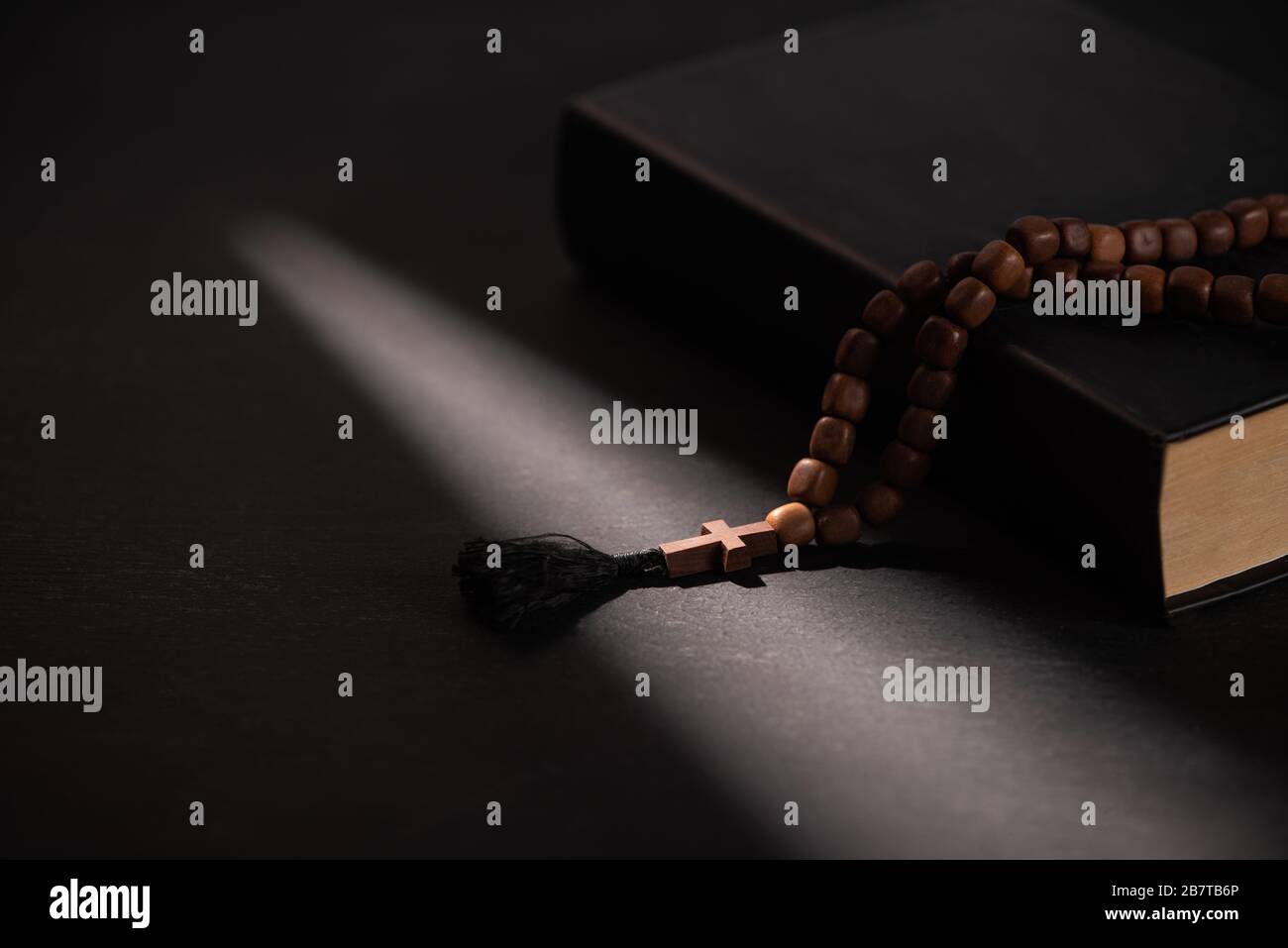holy bible with rosary on black dark background with sunlight Stock ...