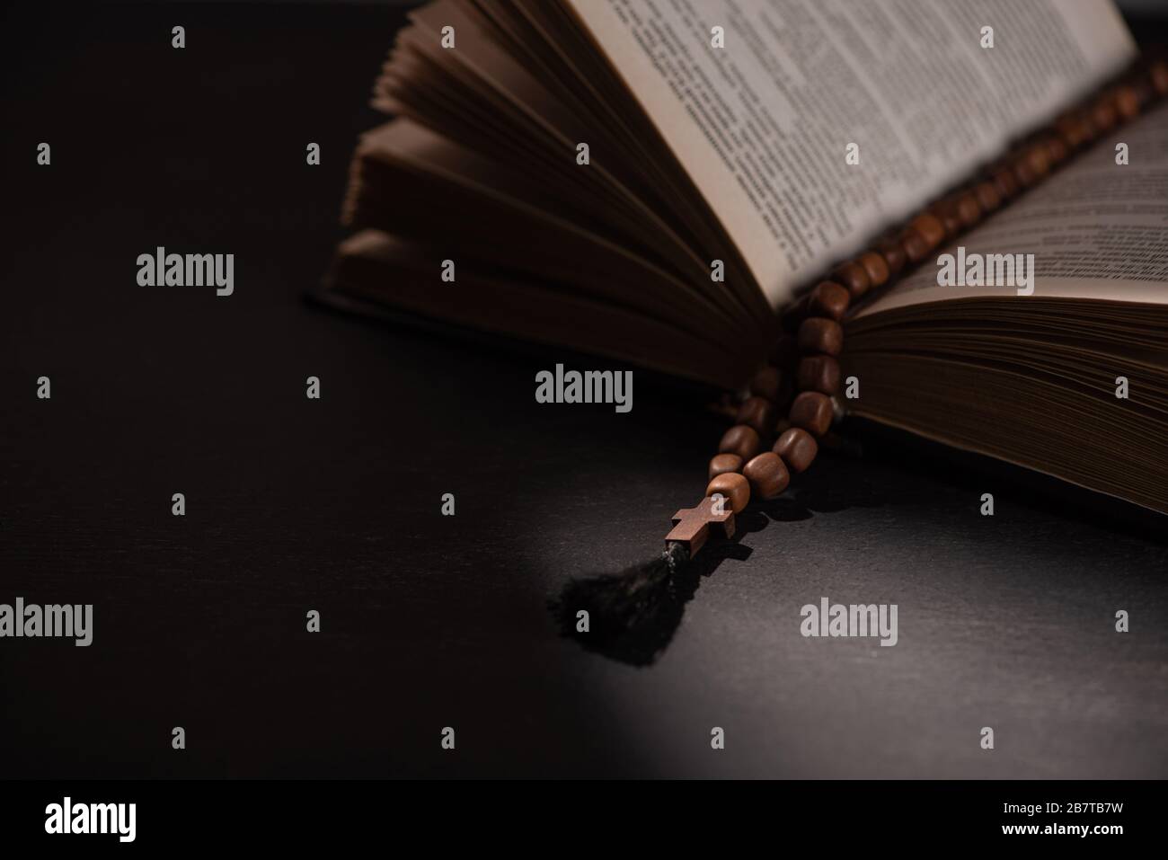 holy bible with rosary on black dark background with sunlight Stock ...