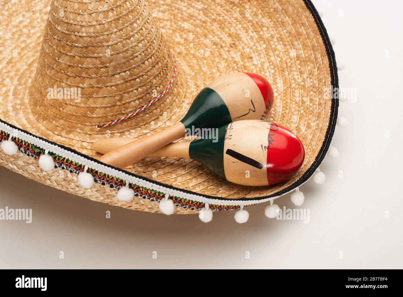 Close up view of wooden maracas on sombrero on white background Stock ...