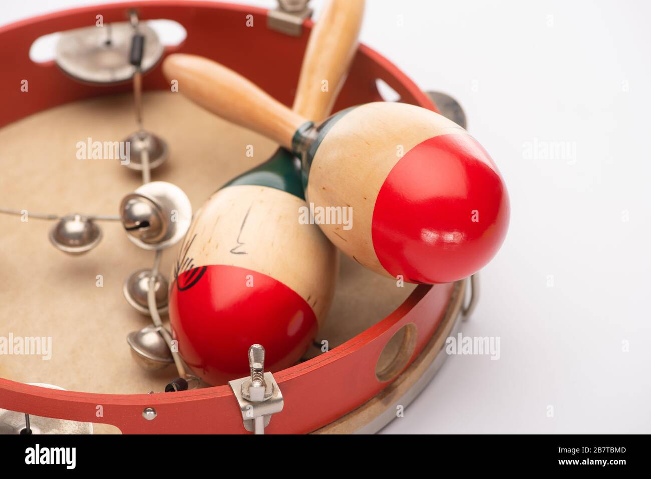 Close up view of wooden maracas on tambourine on white background Stock ...