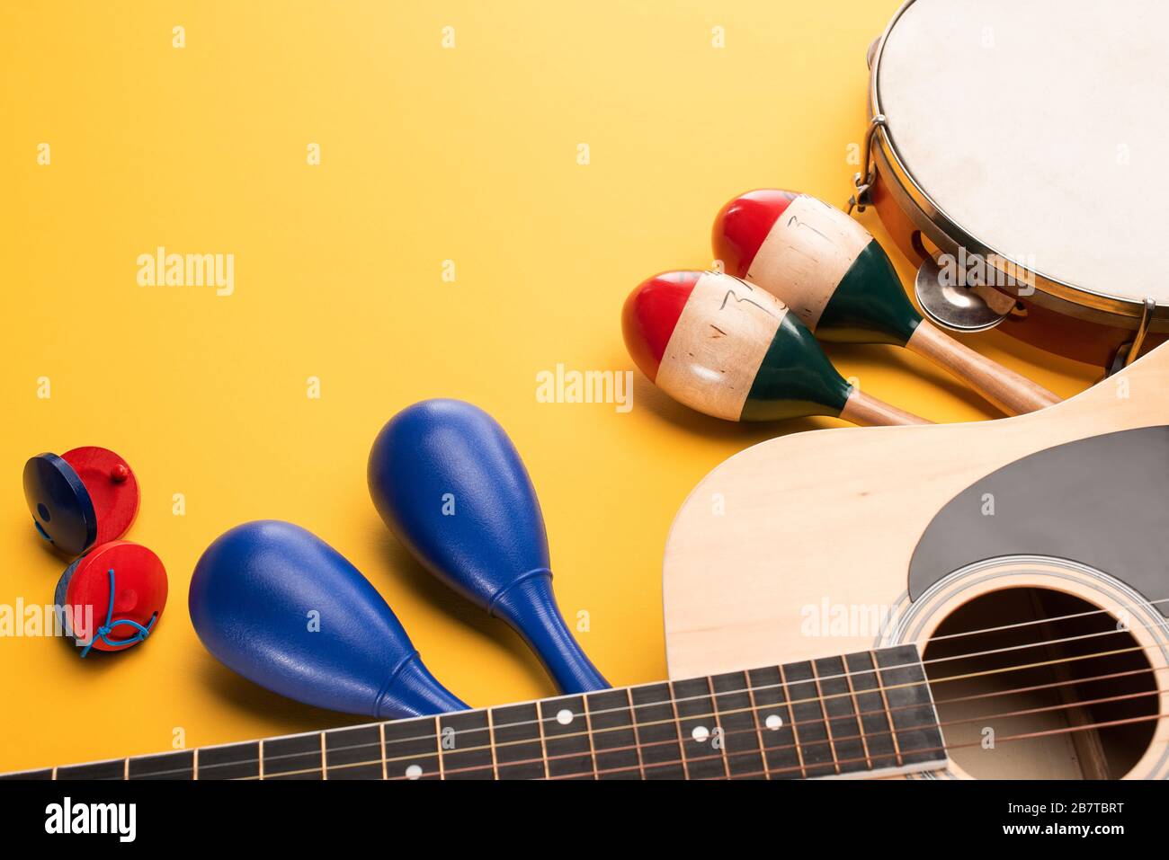Wooden colorful and blue maracas with tambourine, castanets and ...