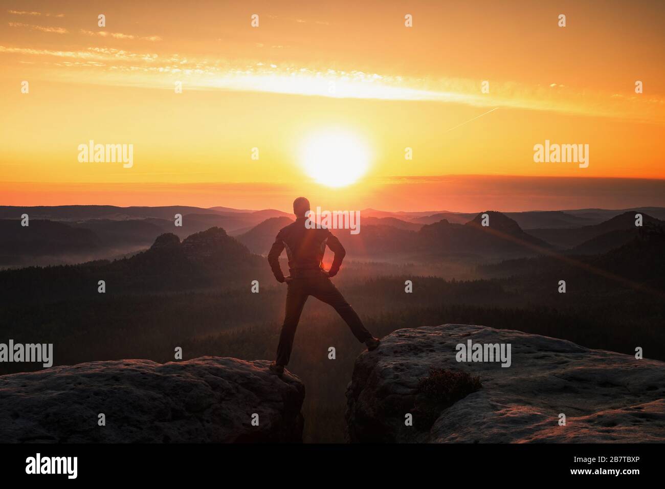 Man hiking silhouette in mountains, sunset jumping. Male hiker with ...