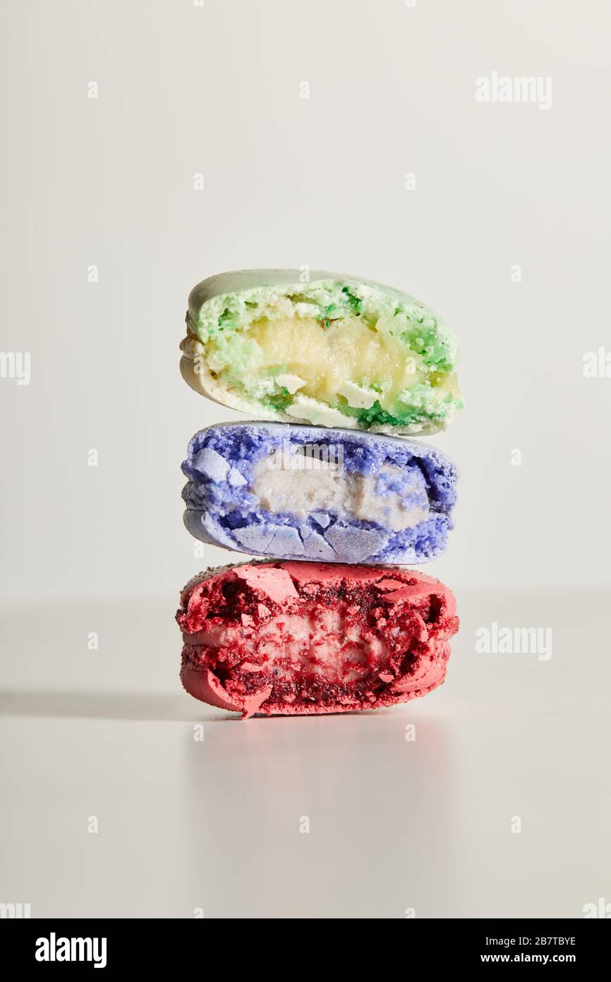 assorted delicious bitten colorful french macaroons on white background ...
