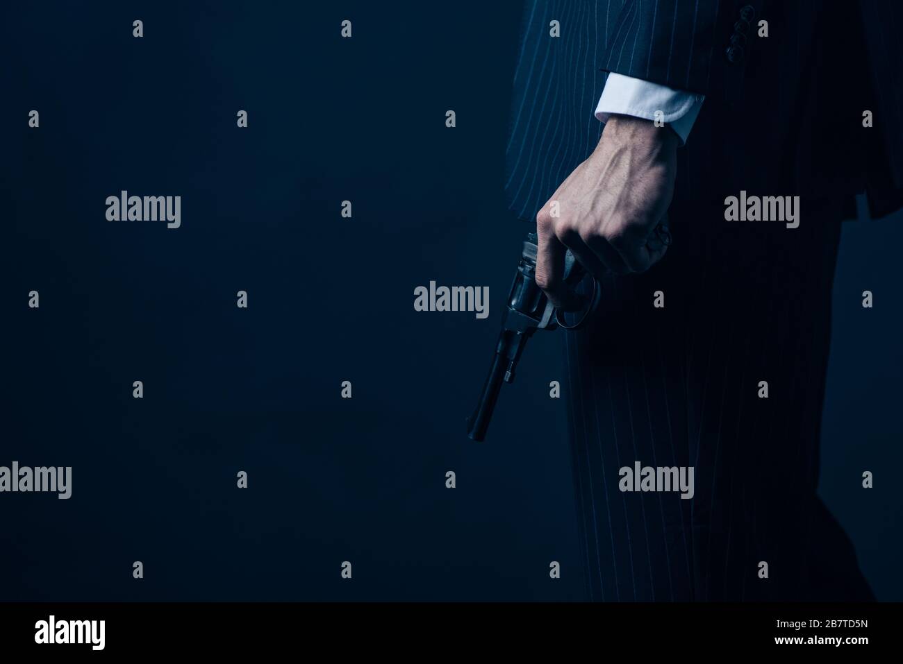 Young handsome man holding hand gun hi-res stock photography and images ...