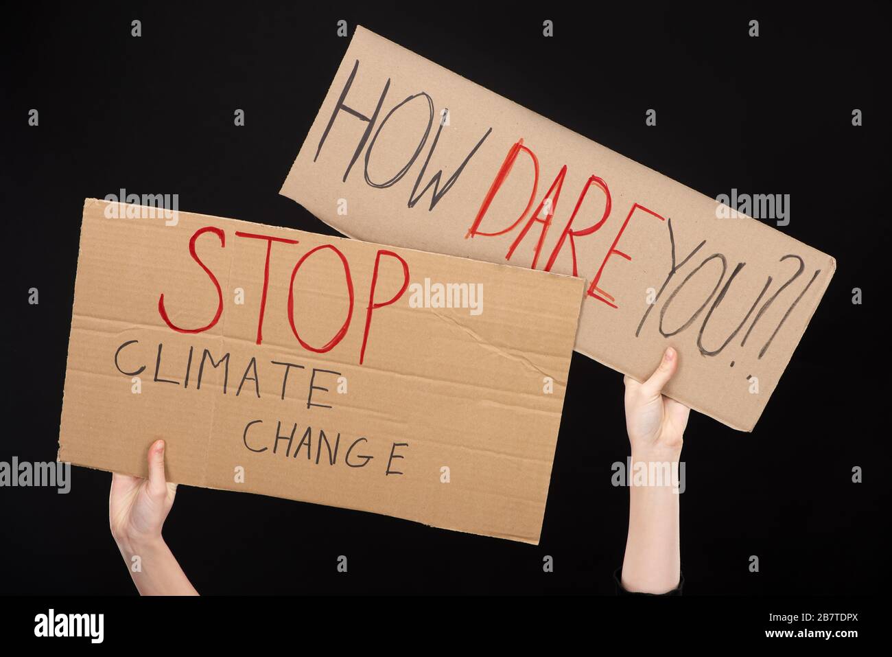 Cropped view of woman holding placards with how dare you and stop ...
