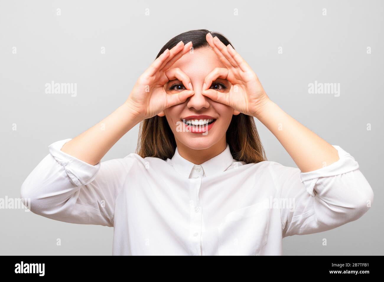 vision aids. young woman holding her hands over her eyes imitating ...