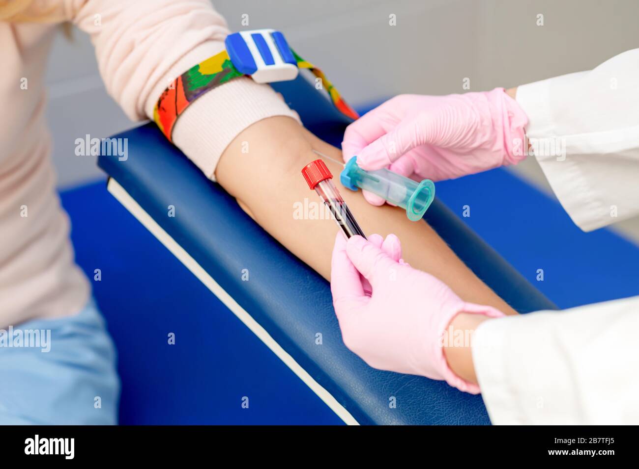 Nurse taking blood sample from patient for analysis of coronavirus ...