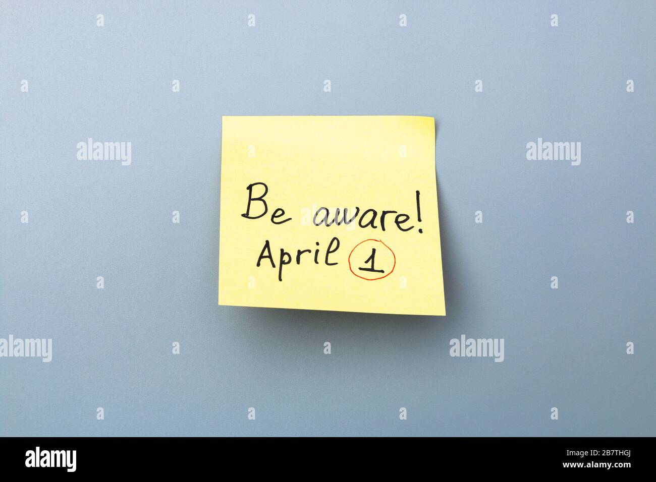 be aware on yellow sticky note over a grey background. april fools day ...