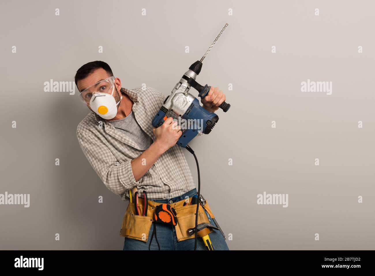 Workman holding electric drill hi-res stock photography and images - Alamy
