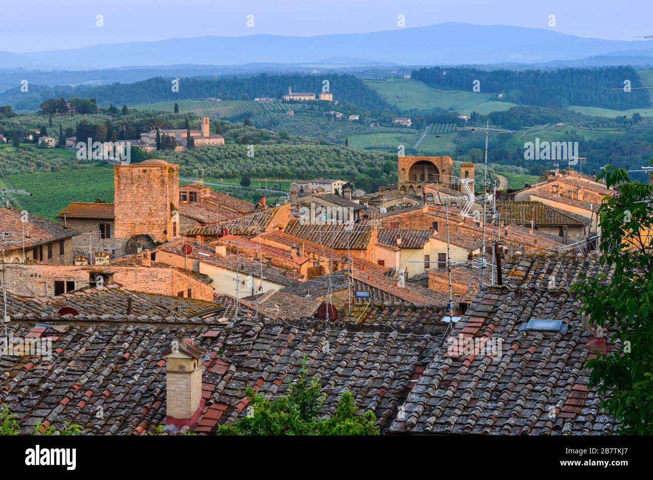 Rooftops of San Gimignano, Tuscan countryside with rolling hills and ...