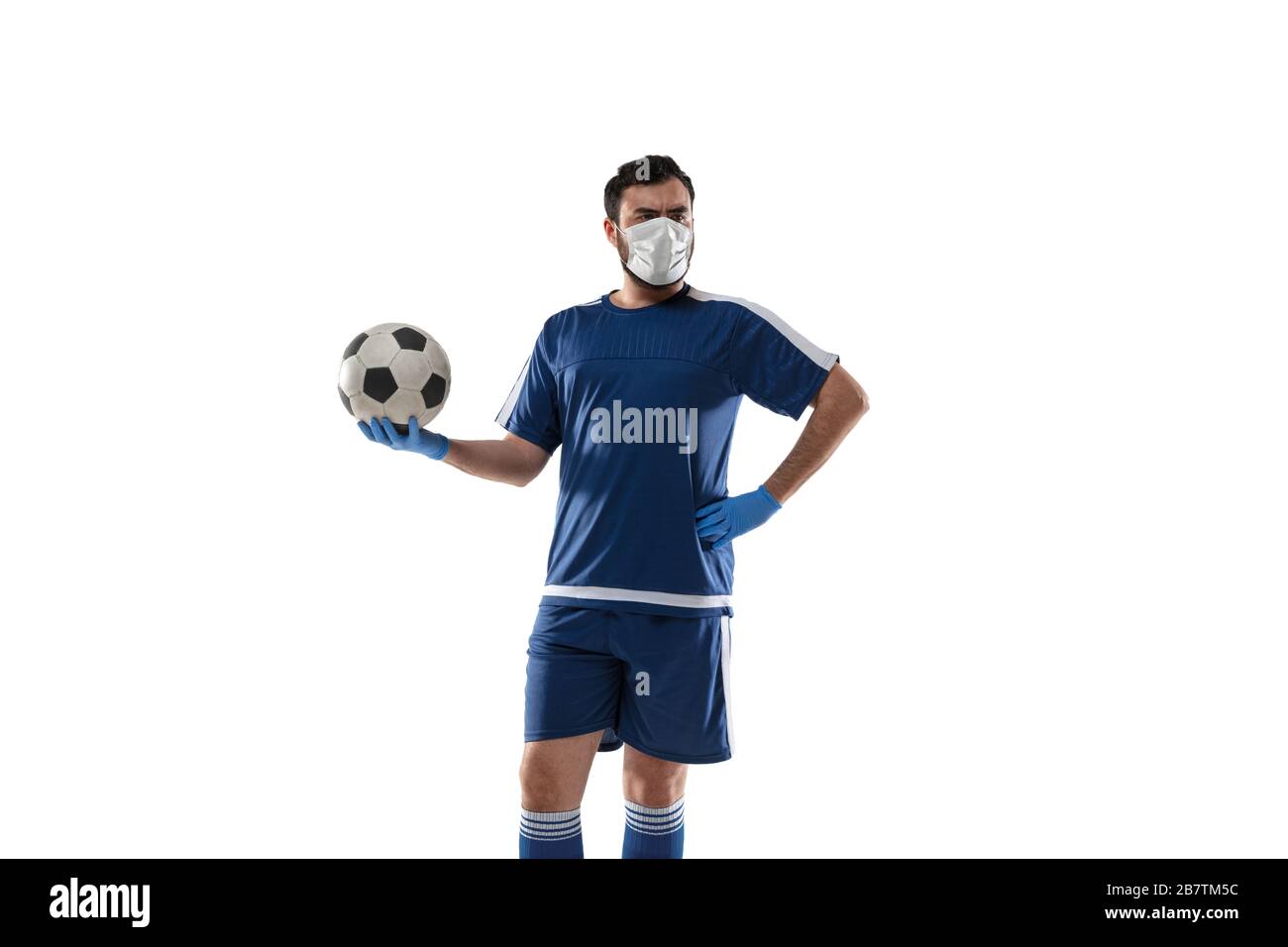 Punching virus. Football, soccer player in protective mask and gloves ...
