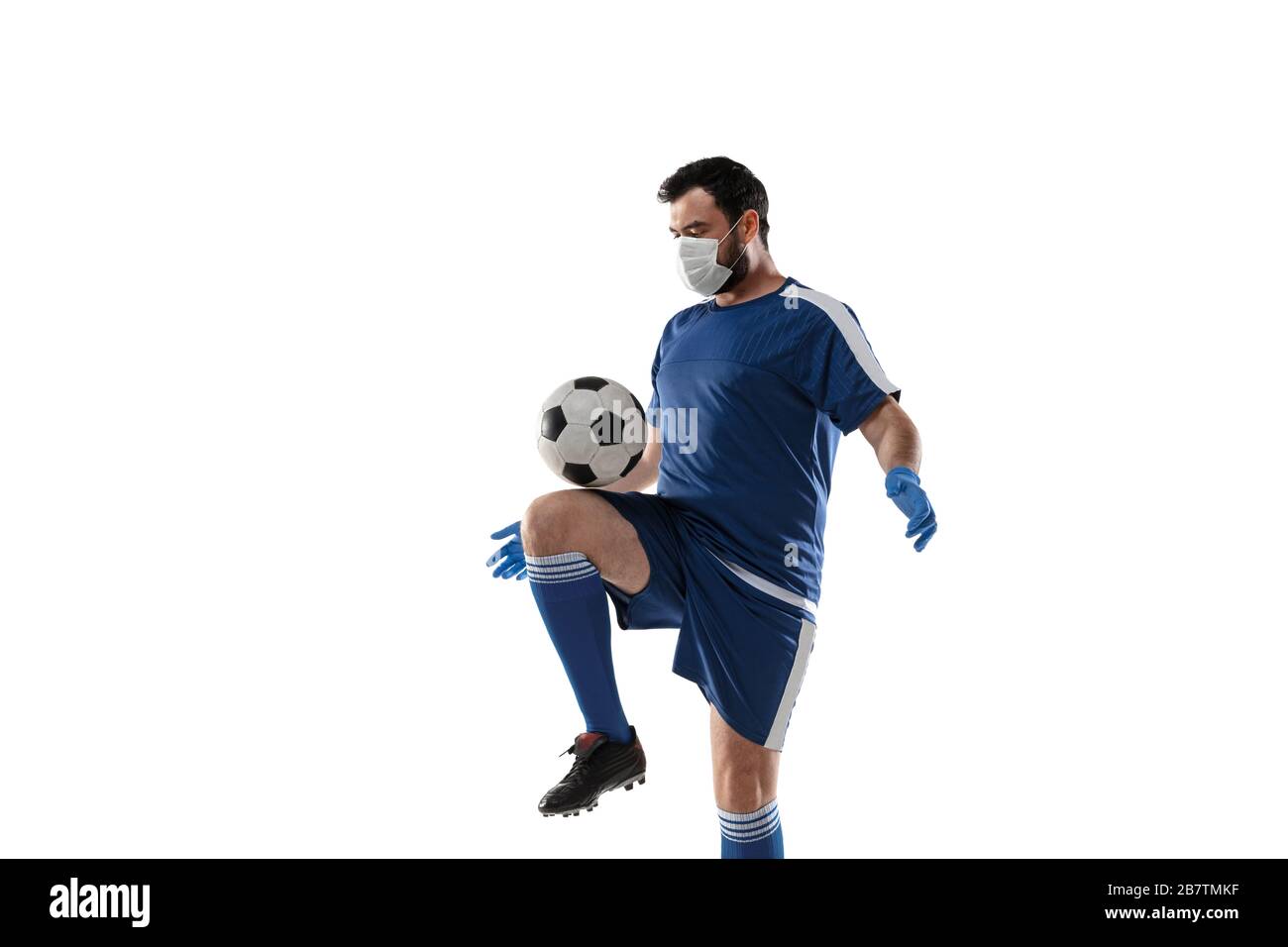 Punching virus. Football, soccer player in protective mask and gloves ...