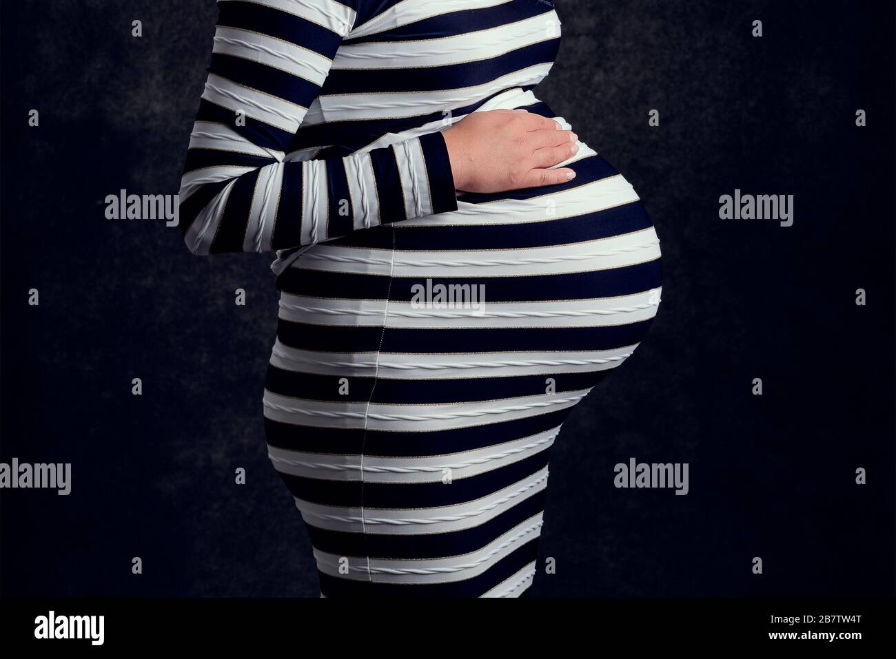 Woman with pregnancy belly, studio photos Stock Photo - Alamy