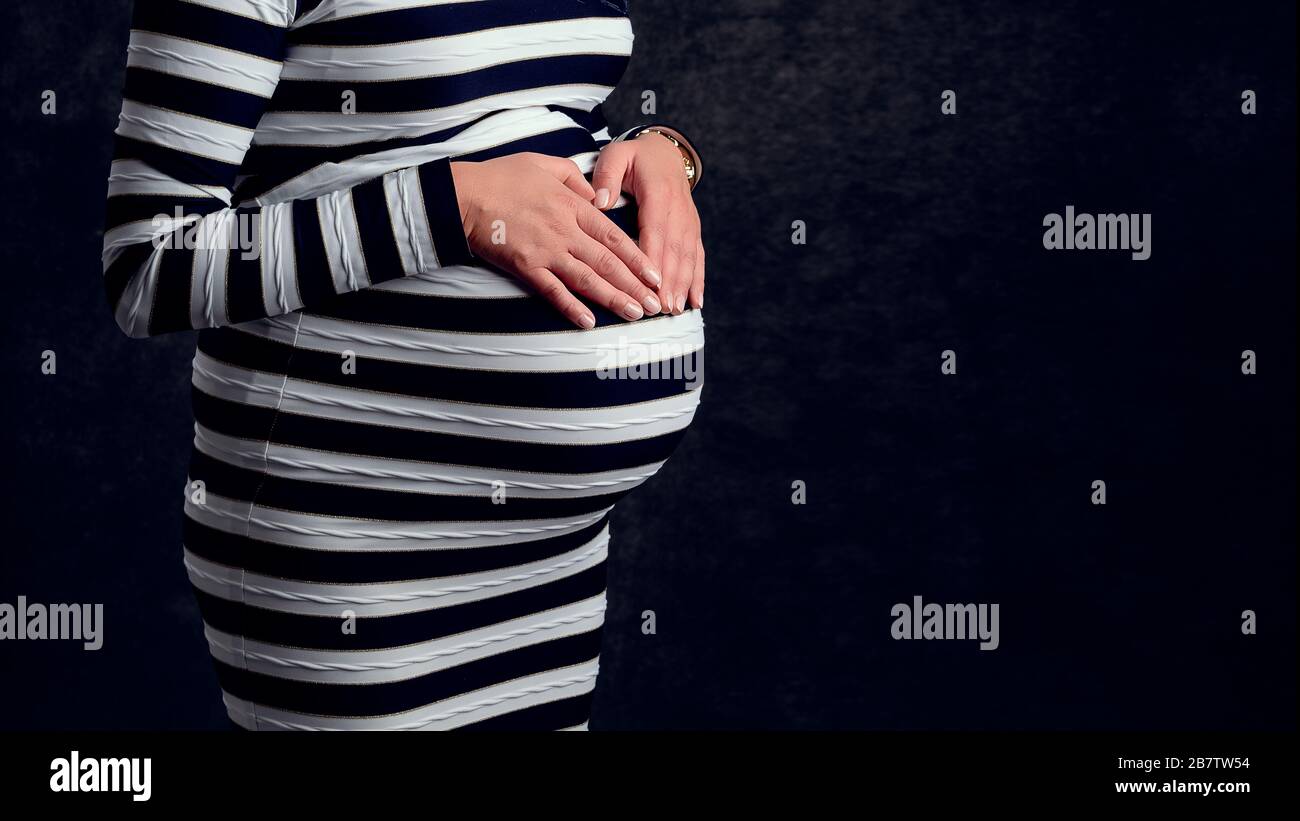 Woman with pregnancy belly, studio photos Stock Photo - Alamy