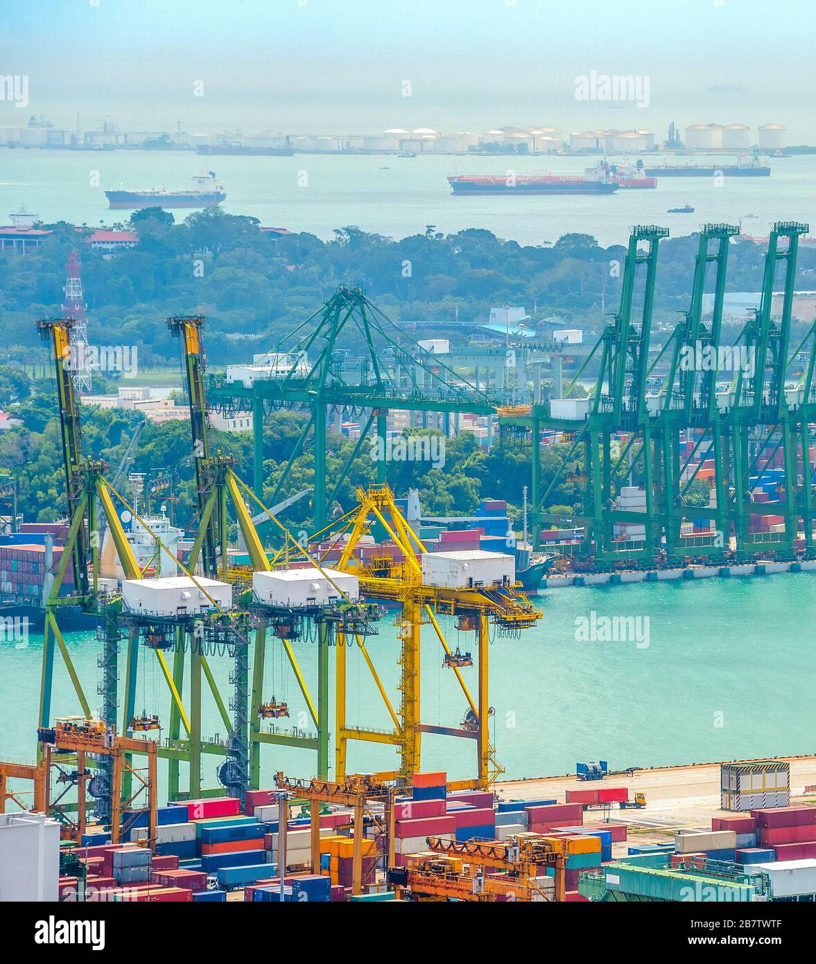 Singapore commercial port, shipping containers freight cranes, cargo equipment, skyline with ...