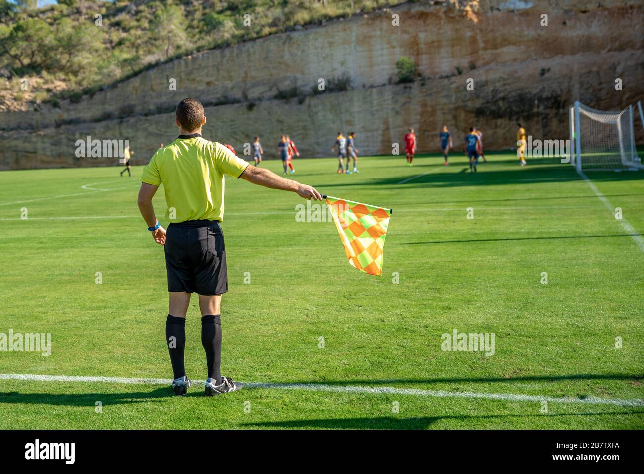assistant referee in a football match watching the game Stock Photo - Alamy
