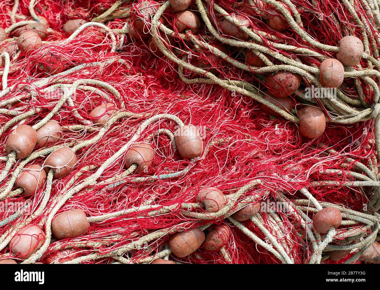 red fishing nets with floats used to fish at sea Stock Photo - Alamy