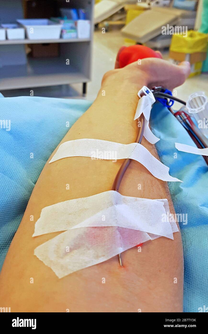 Arm of a volunteer Blood donor with surgical needle at the hospital ...