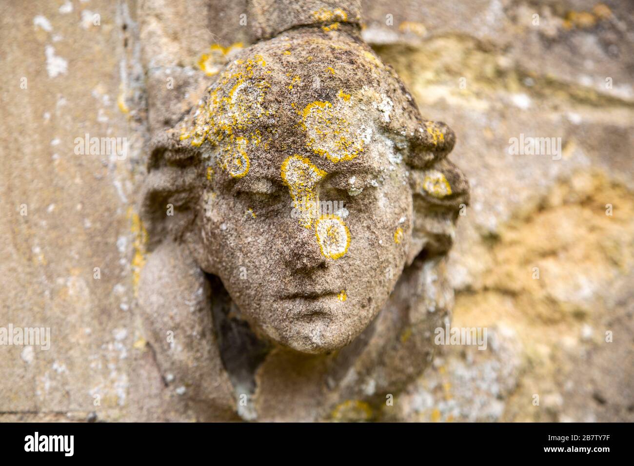Carved stone head and face weathered figure on exterior of Brantham ...