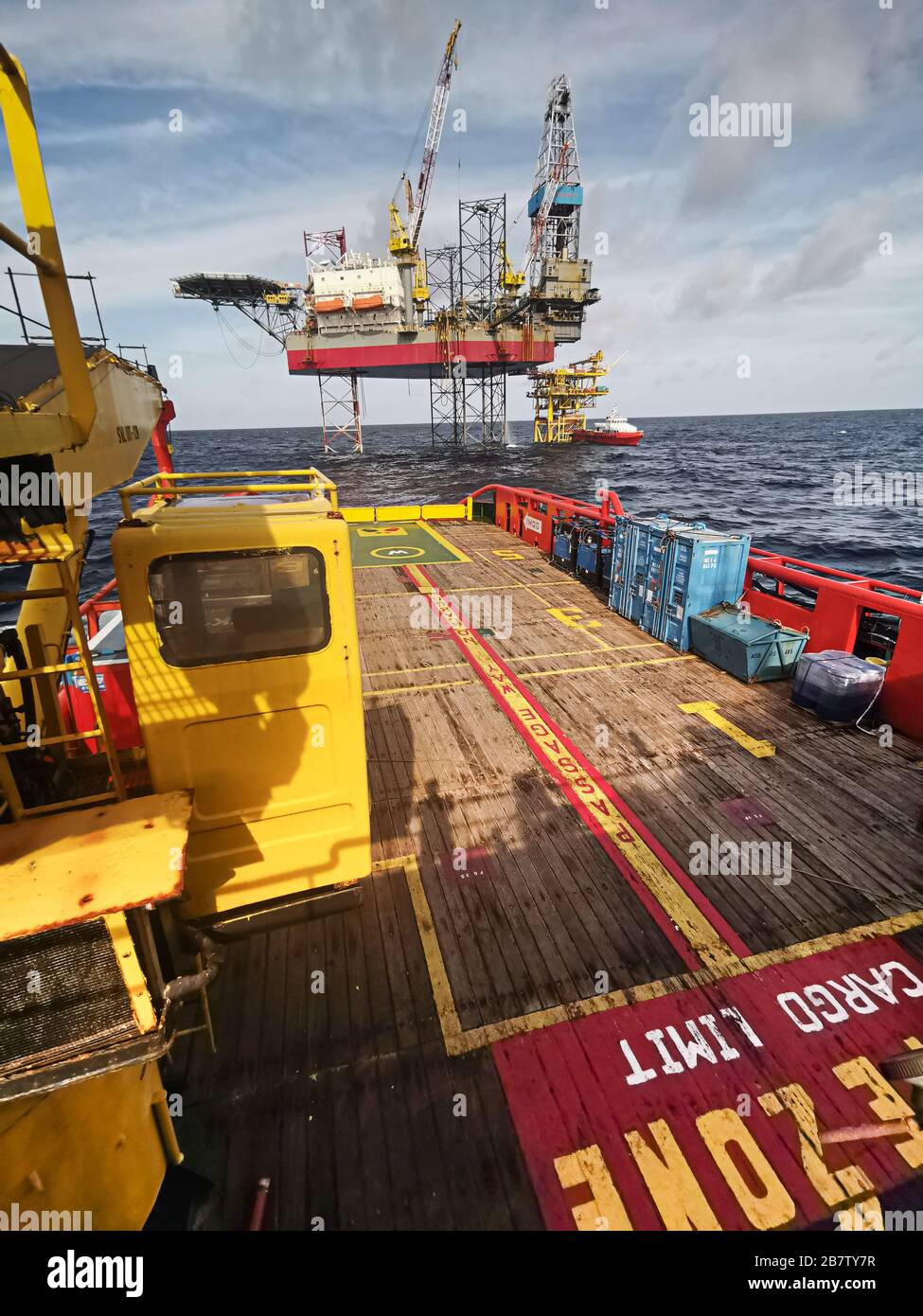 AHTS (anchor handling towing and supply) vessel in 500 meter zone and approaching jack up rig as ...