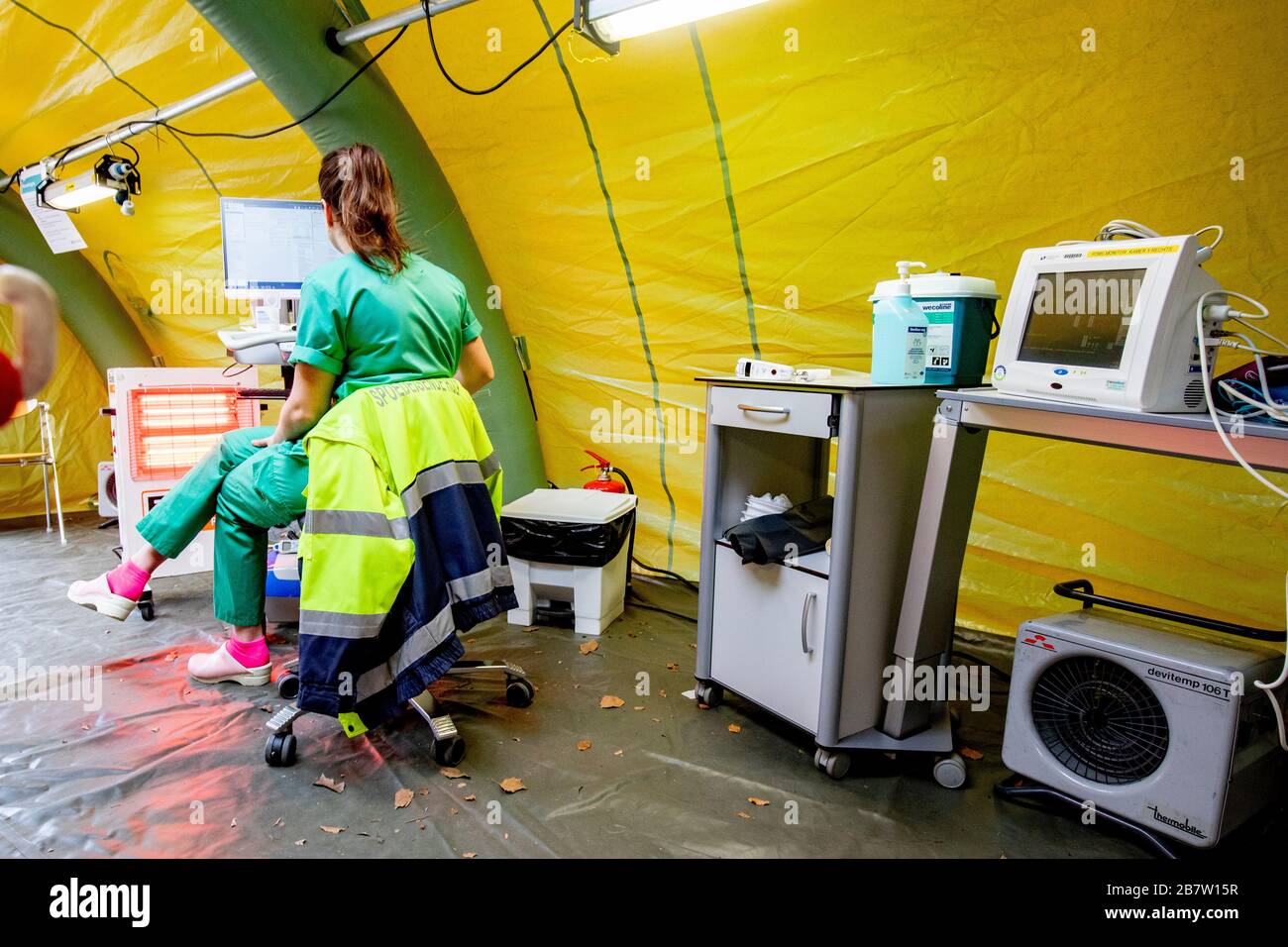 A nurse waits for new patients in an emergency tent that was placed at ...