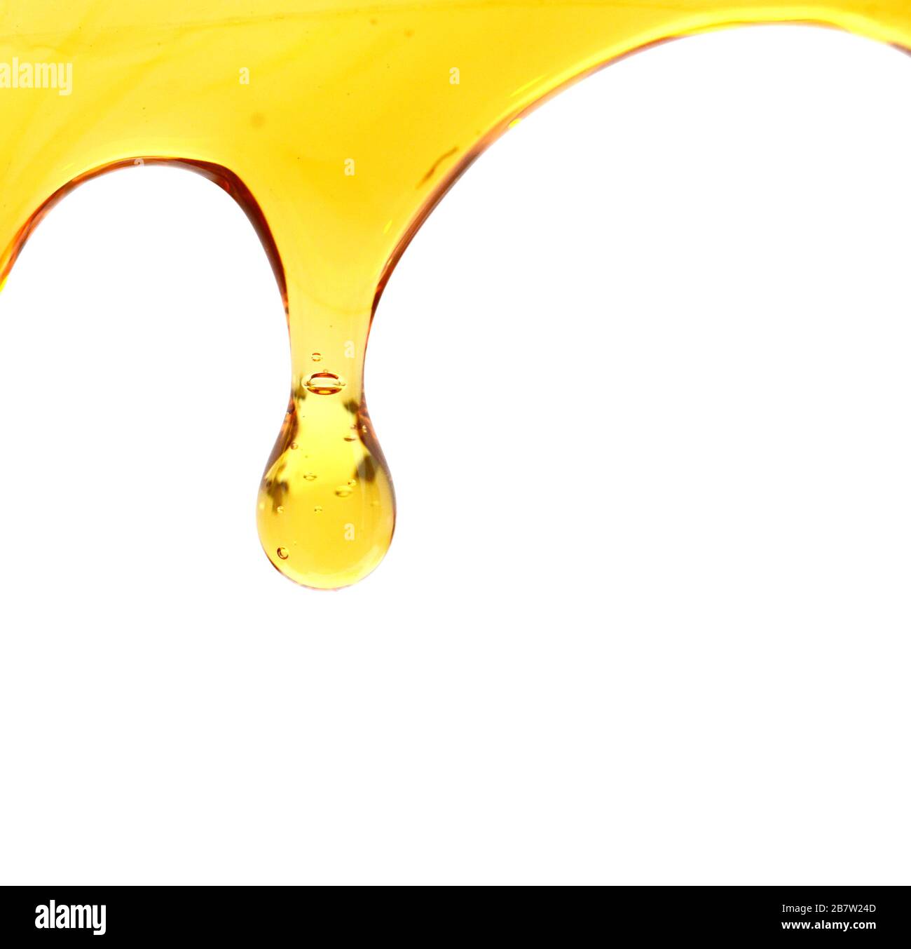 Flow of sweet honey on the white background Stock Photo - Alamy