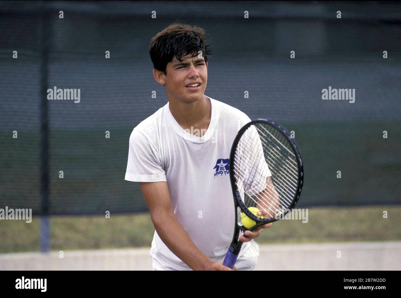 Austin, Texas USA: Teenage boy prepares to serve during summer tennis ...