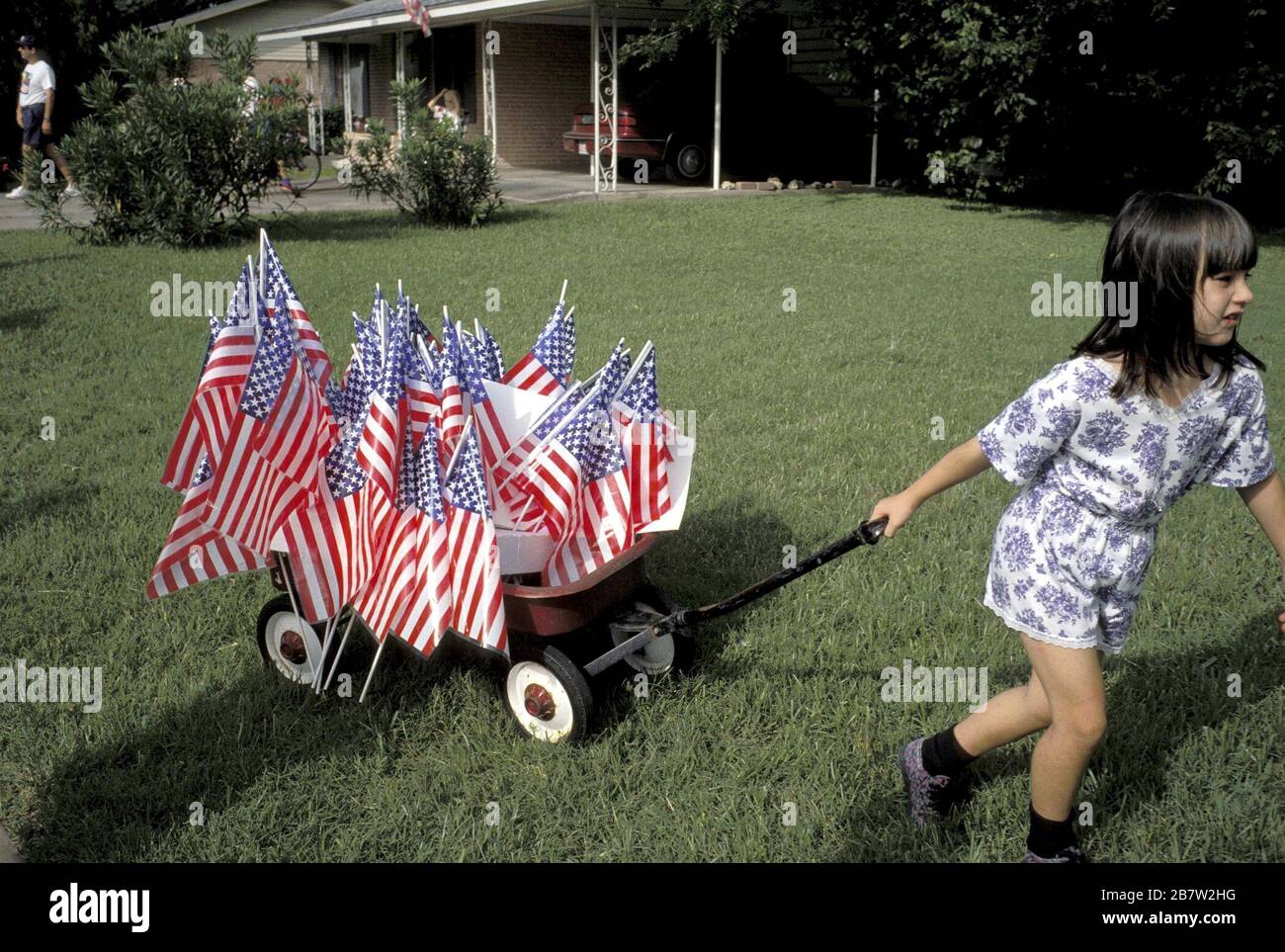 Austin, Texas USA: Child pulling wagon with American flags on her way ...