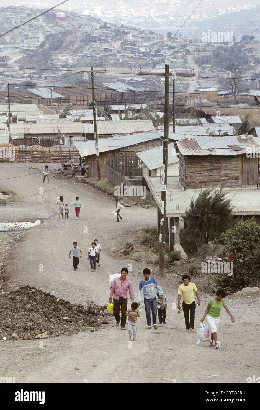 Tegucigalpa, Honduras: Residents walking up steep road at hillside ...