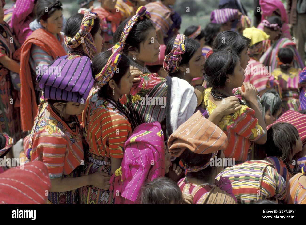 Guatemala: Crowd of women and children wearing colorful traditional ...