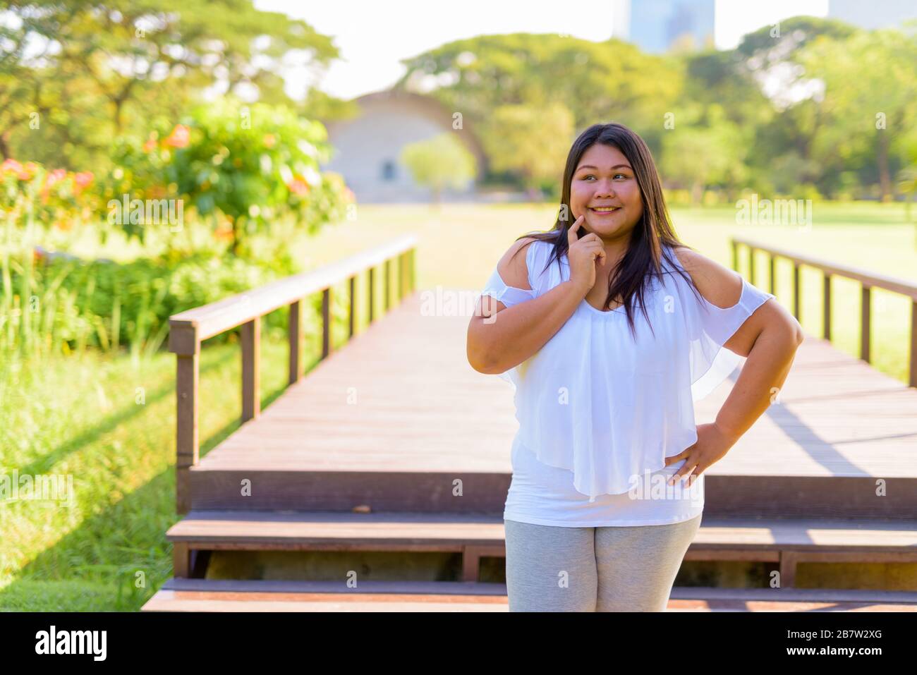 Happy overweight asian woman thinking hi-res stock photography and ...