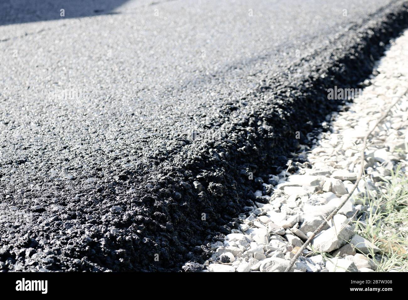New layer of asphalt road under construction with support from the ...