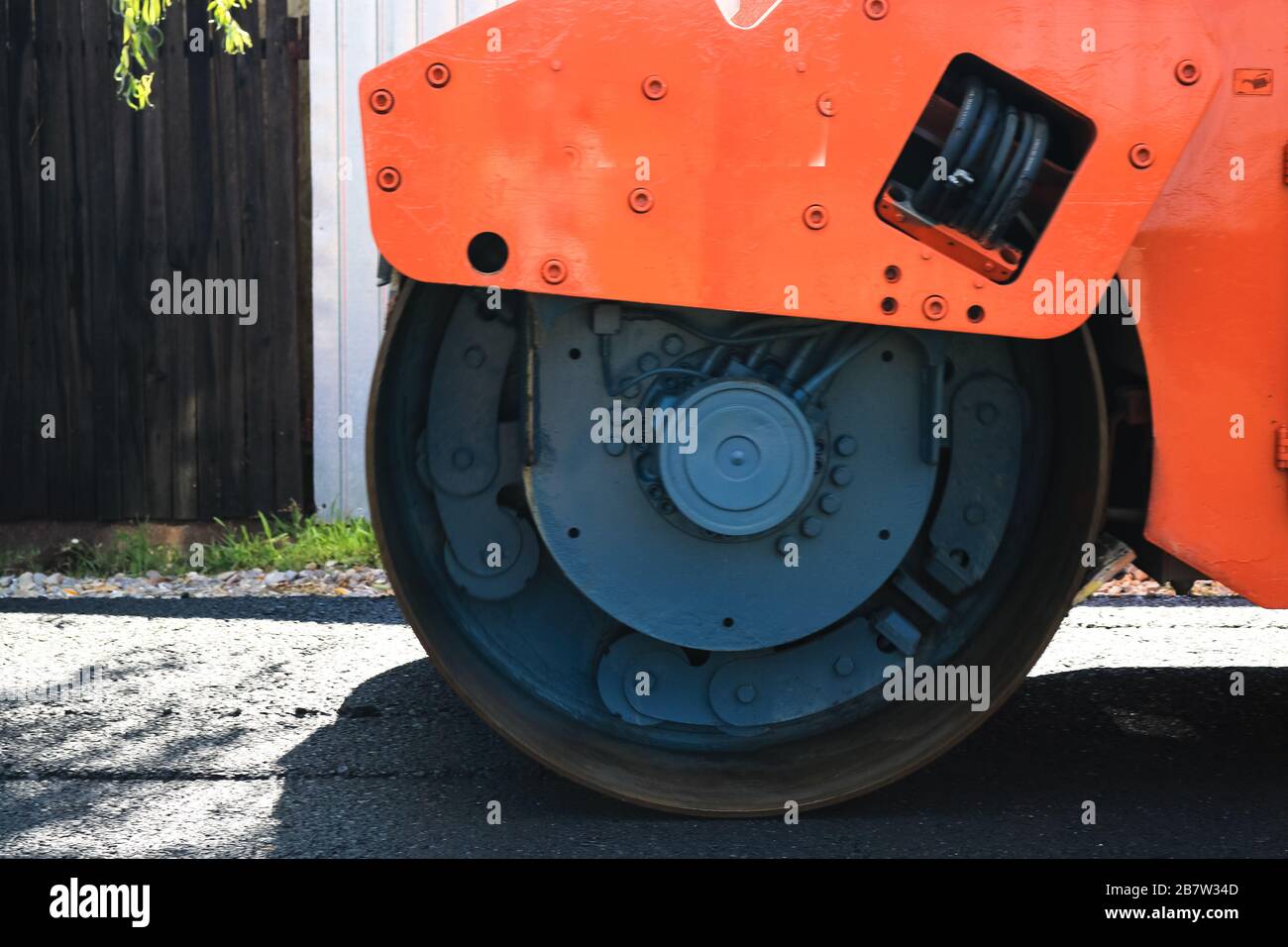 Workers and asphalting machines. Heavy road roller in motion on the ...