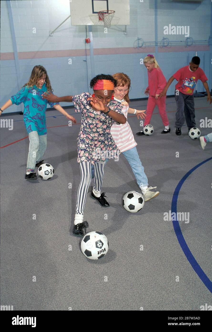 Austin, Texas USA: Fifth grade students practice dribbling soccer balls ...