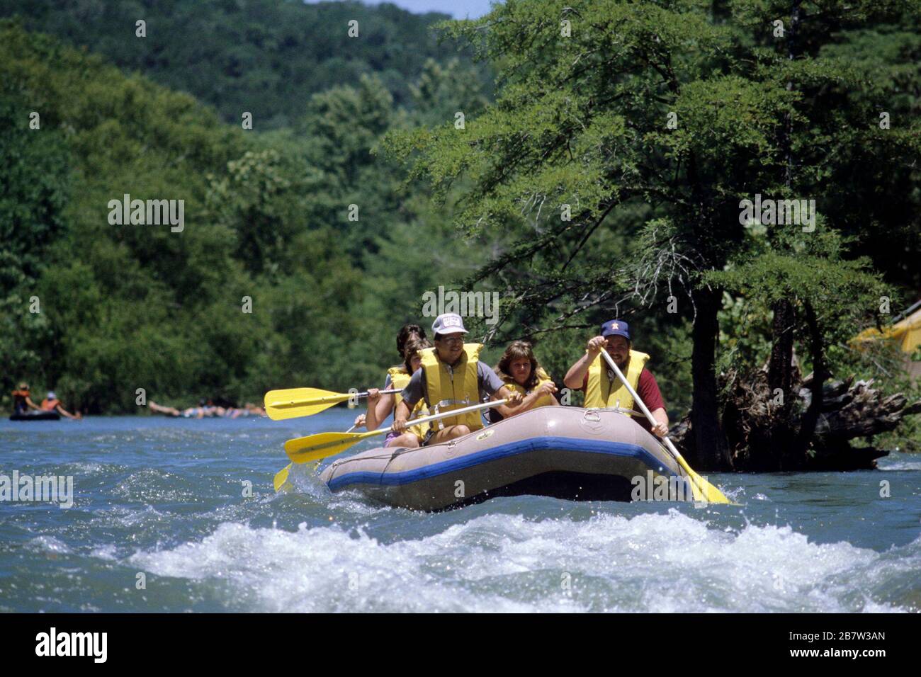 Texas: Tourists paddling inflatable raft enjoy summer water sport on ...