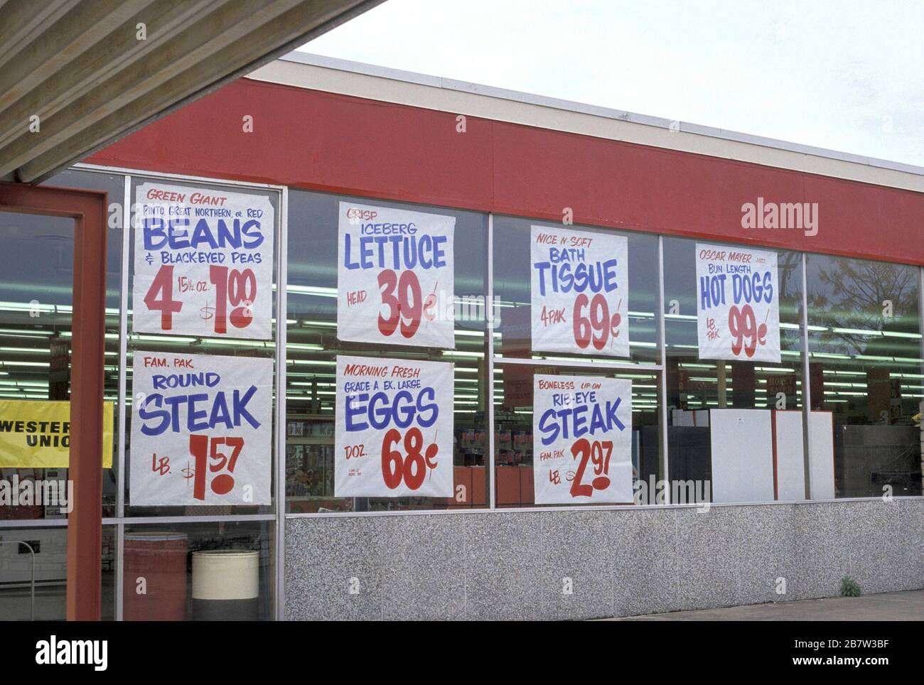 Food price signs in window of small supermarket. ©Bob Daemmrich Stock ...