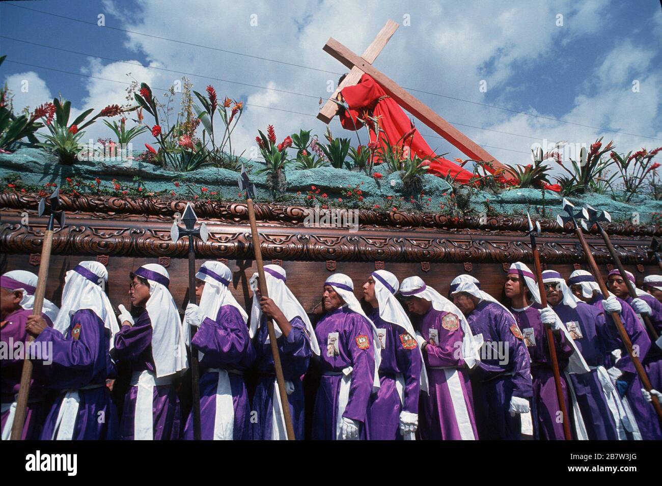 Antigua, Guatemala: Men wearing matching costumes carry a float (anda ...