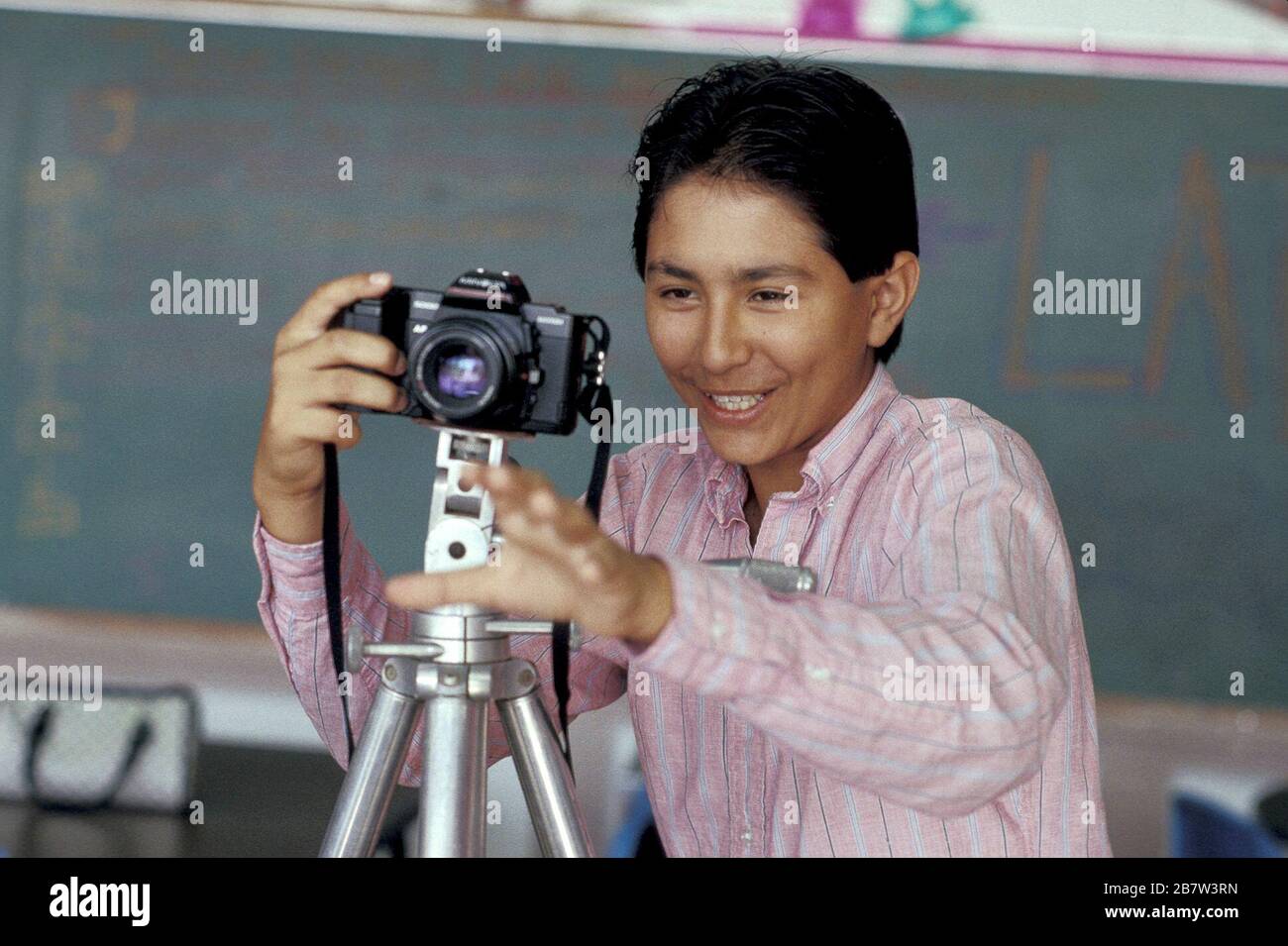 Hispanic high school student in journalism class taking group picture ...
