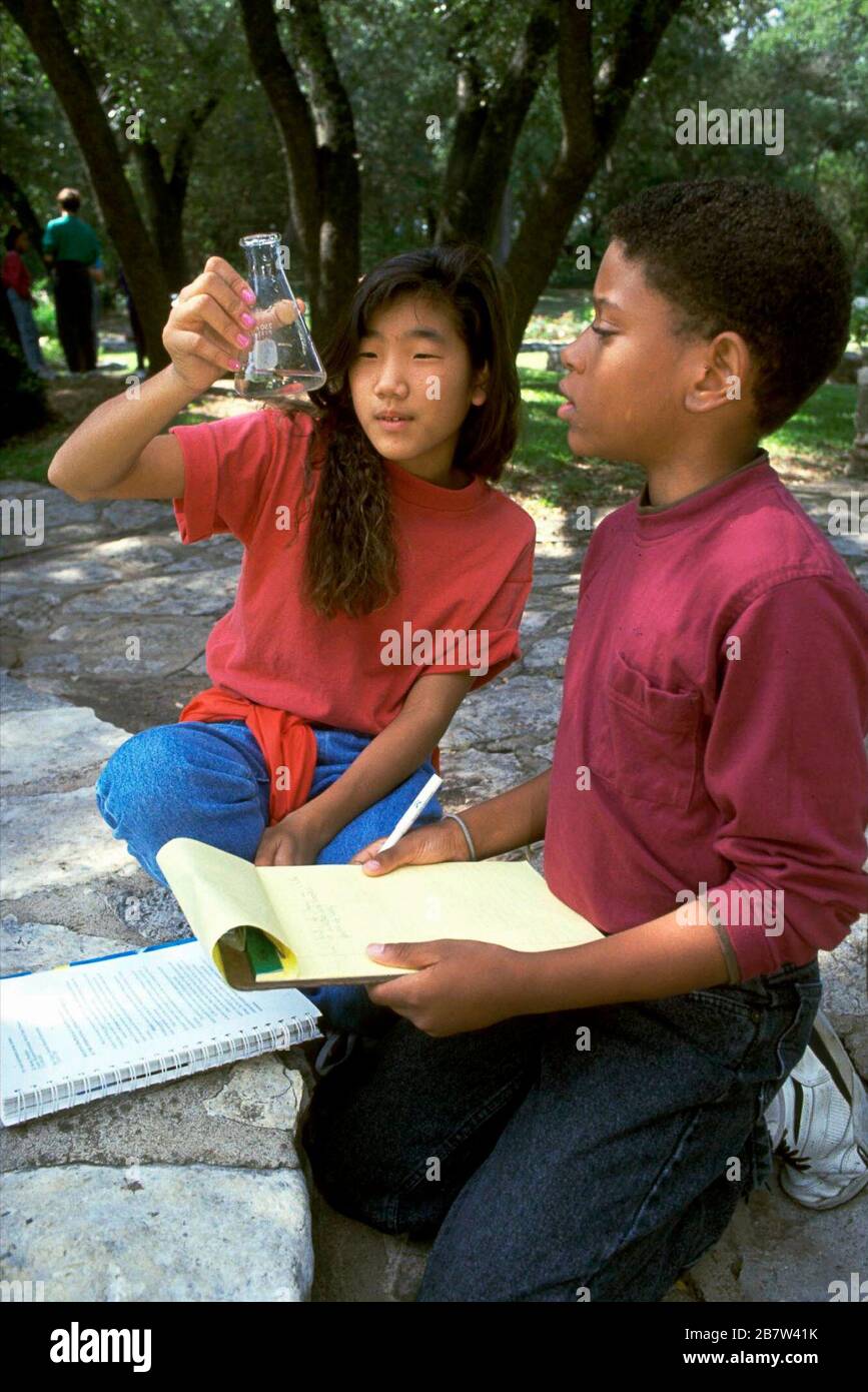 Austin Texas: Middle school classmates observe water sample in beaker ...