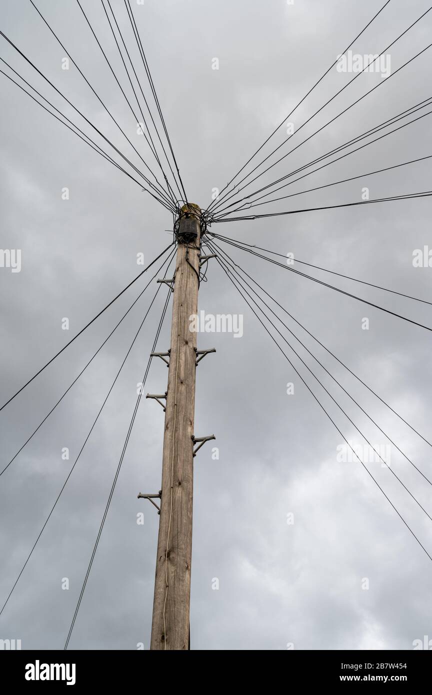 Telegraph pole in a Brixton street, London, with telephone wires ...