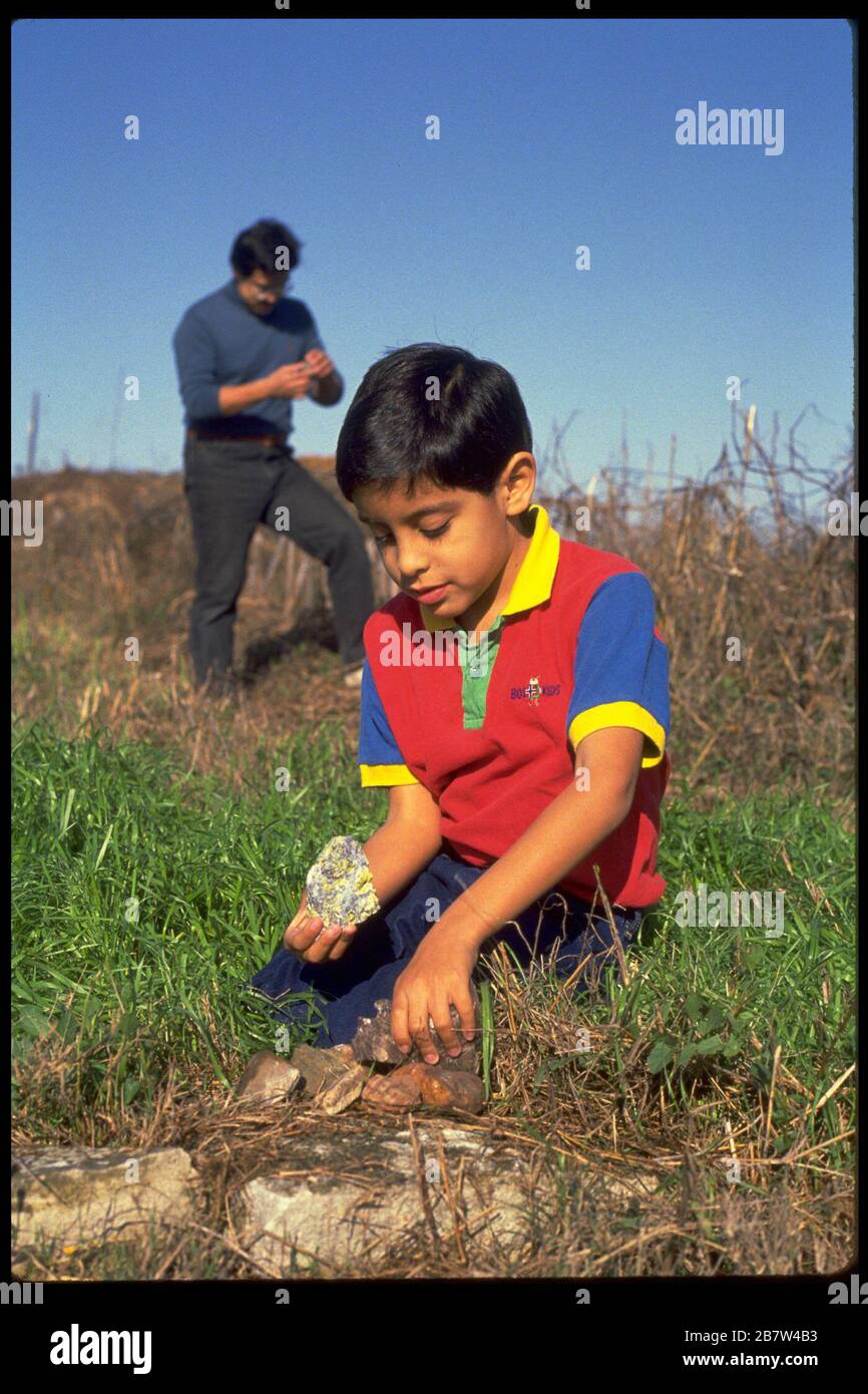 Six Year Old Boy Examining Rocks Found on Hike with Dad MR ©Bob ...